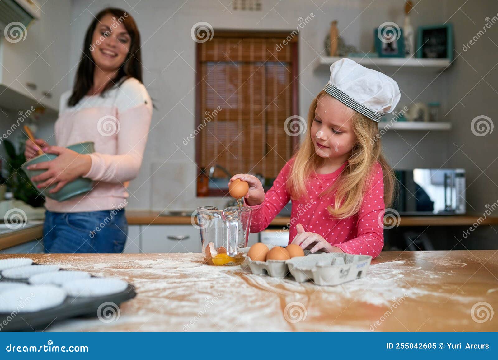 She always Helps Her Mom with the Baking. a Little Girl Baking in the ...