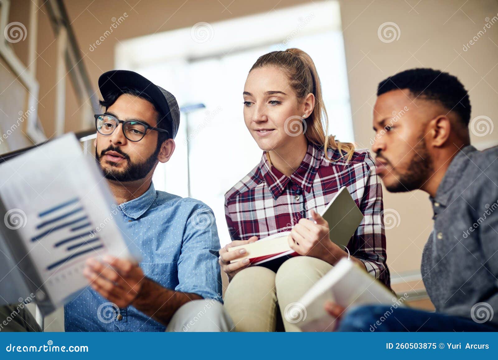 It Helps To Study Together. Three Young University Students Studying on ...