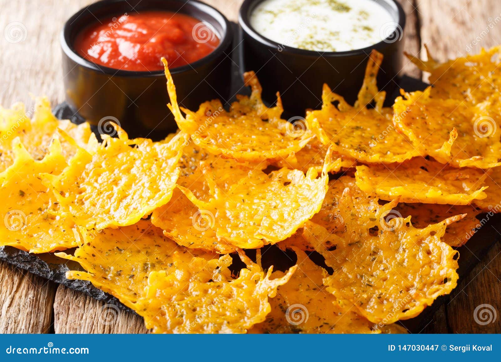 Herb Cheddar Chips Served with Sauces Close-up on a Board. Horizontal ...