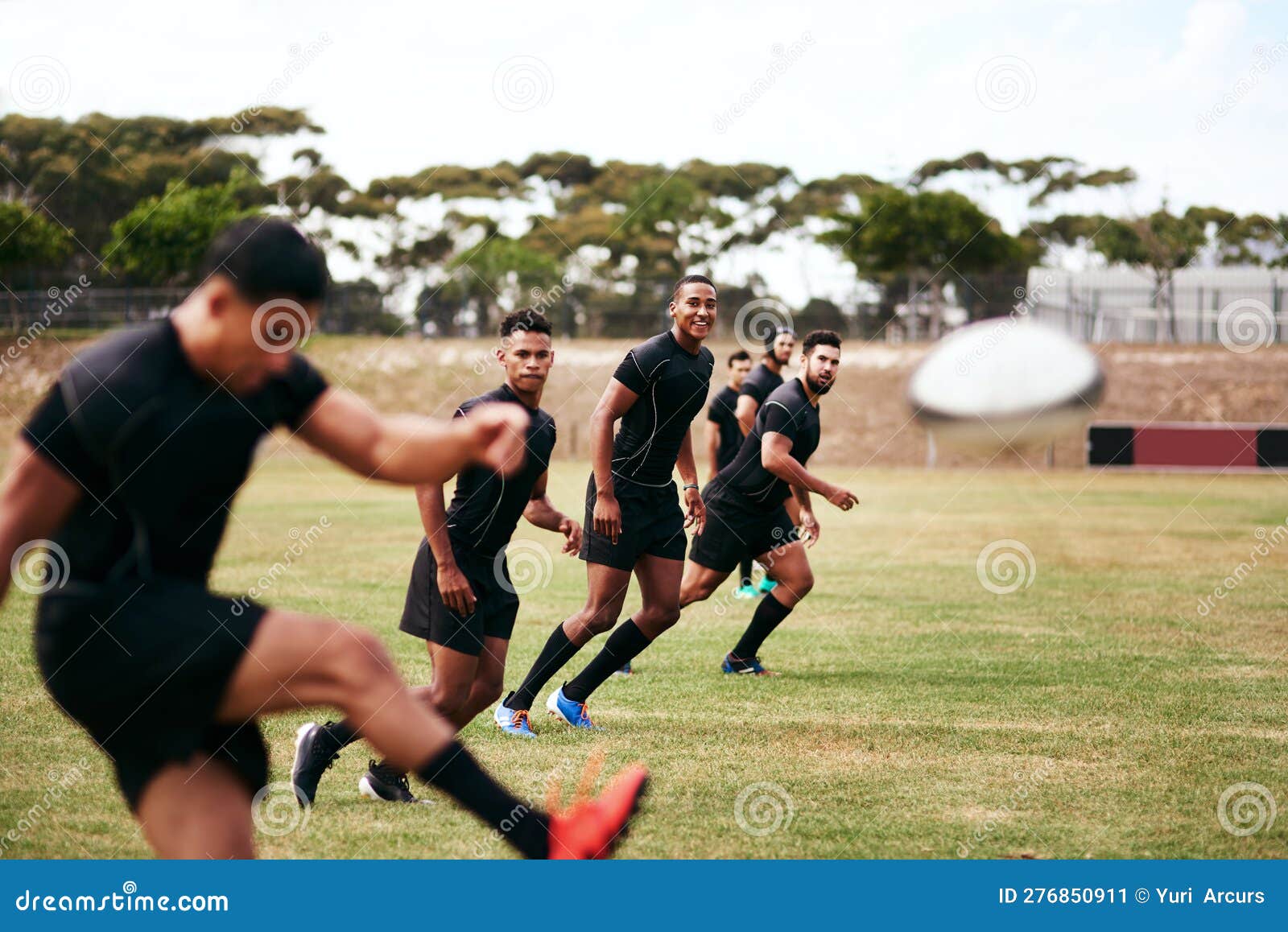 Here Comes the Kickoff. a Group of Young Men Playing a Game of Rugby ...
