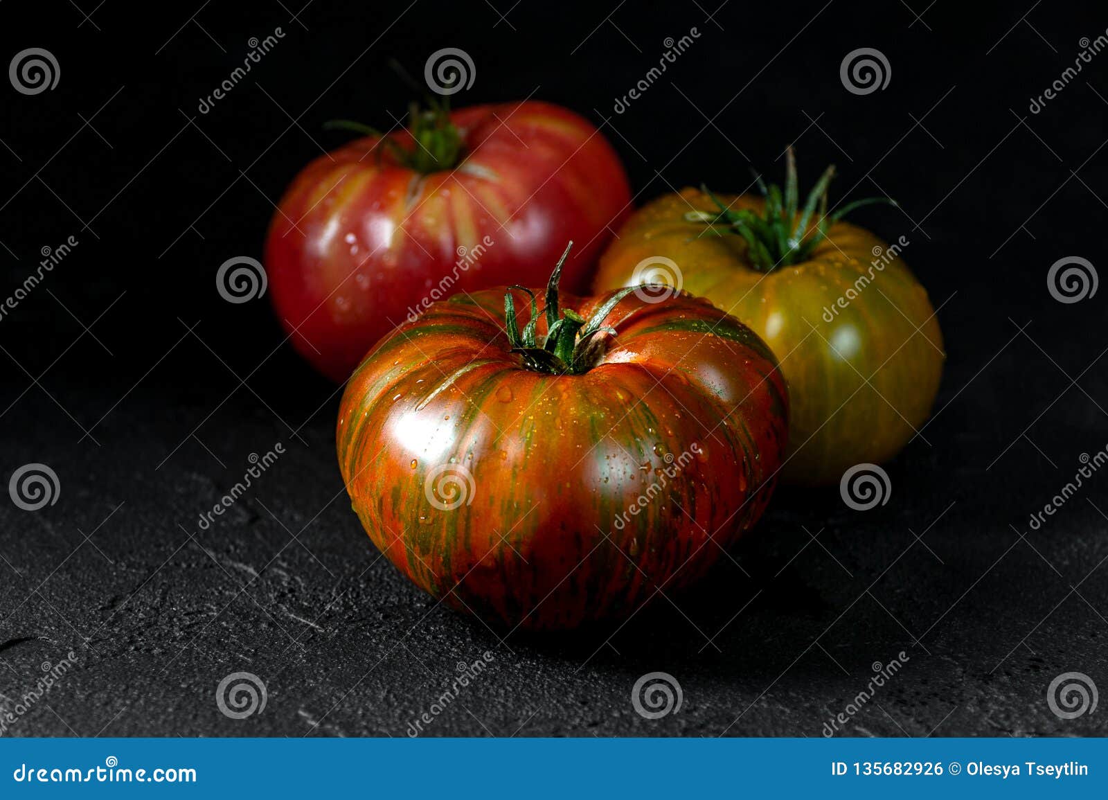 Heirloom Tomatoes. Three Tomatoes of Different Colors on a Black ...