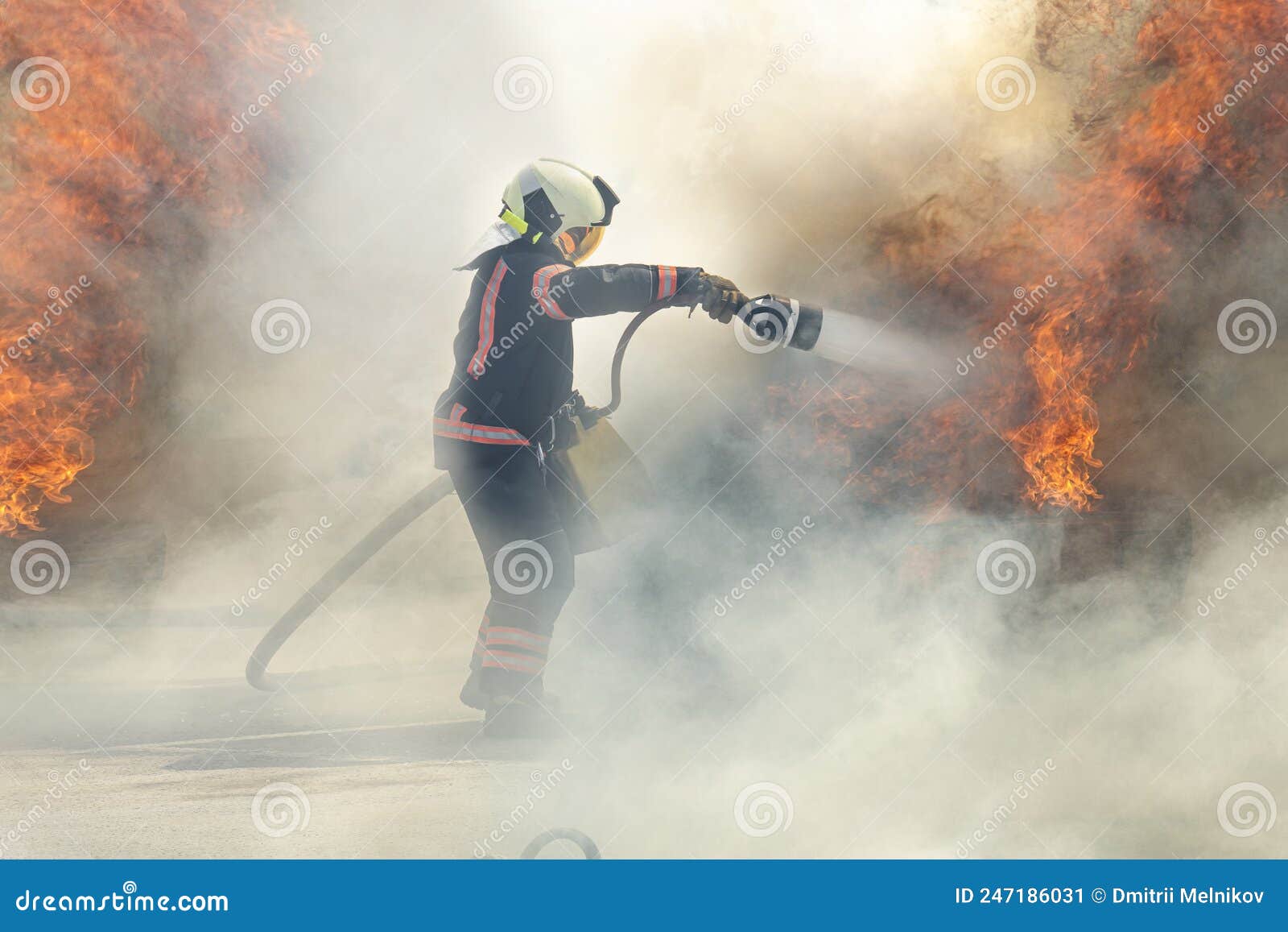 The Hero Firefighter Stands Among The Smoke And Fire And Extinguishes ...