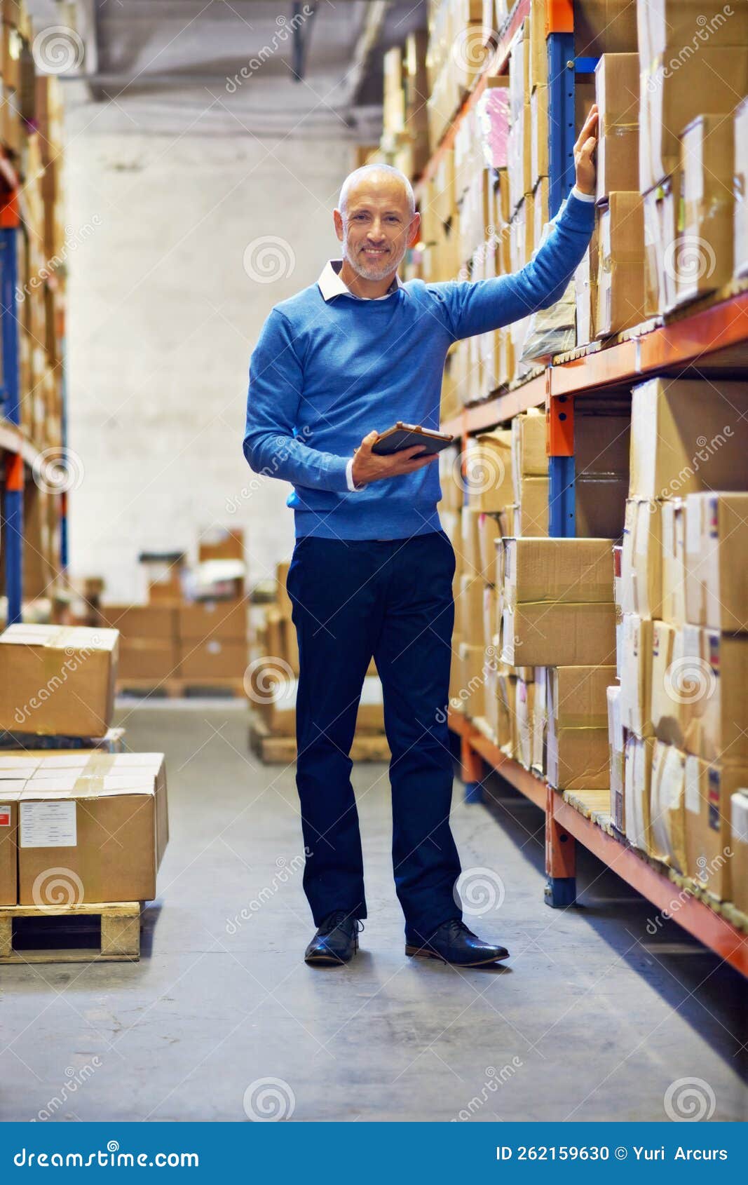 Hes in Charge. a Man Standing Next To Industrial Shelving with Boxes ...