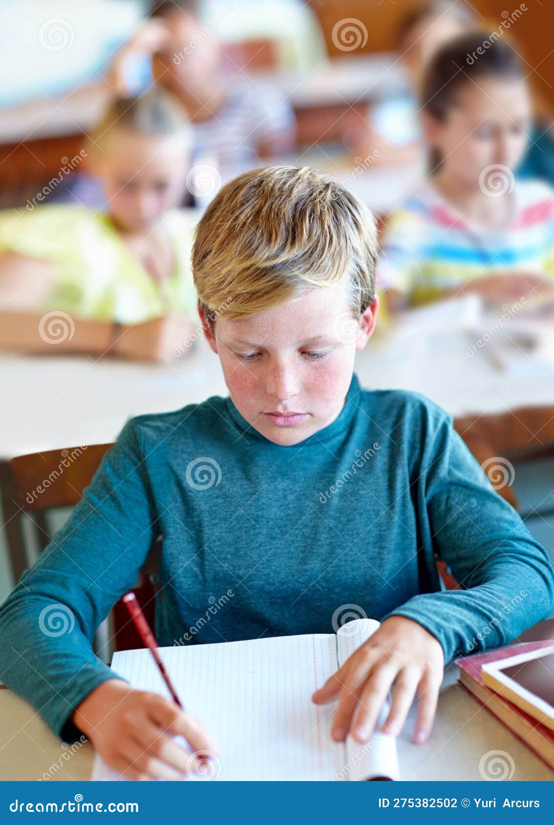 Hes a Diligent Student. a Young Boy Writing in His Notebook during ...