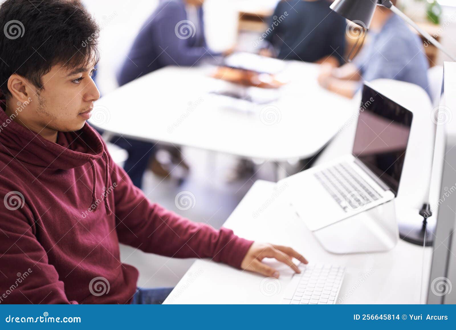 Hes Fully Focused in the Office. a Young Man Working on His Laptop in ...
