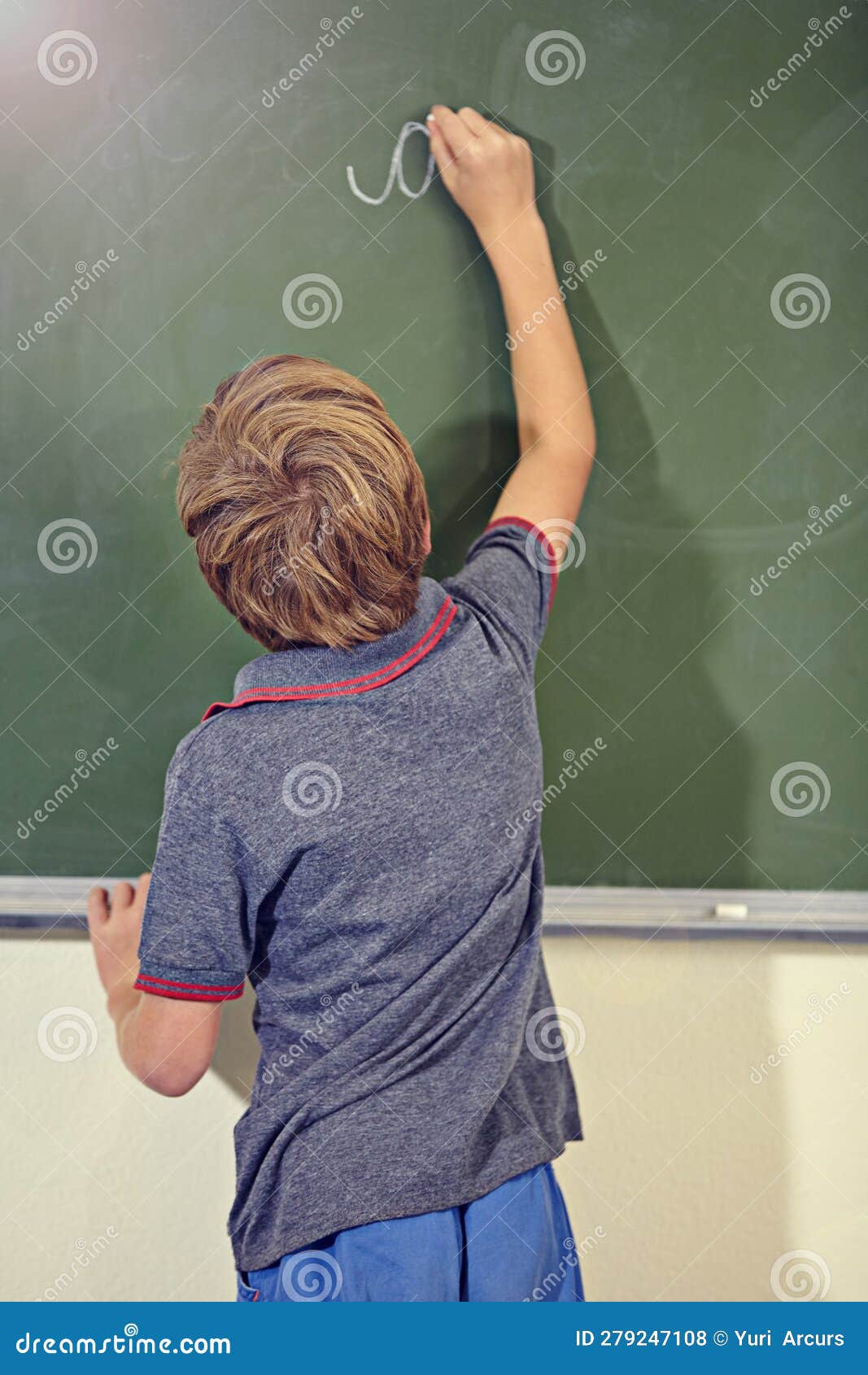 Hes Getting the Hang of this. a Little Boy Writing on the Blackboard ...
