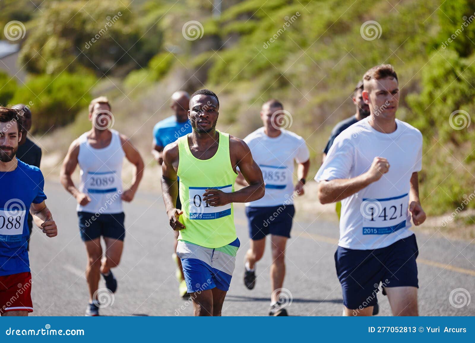 Hes Giving it His All in this Marathon. a Group of Young Men Running a ...