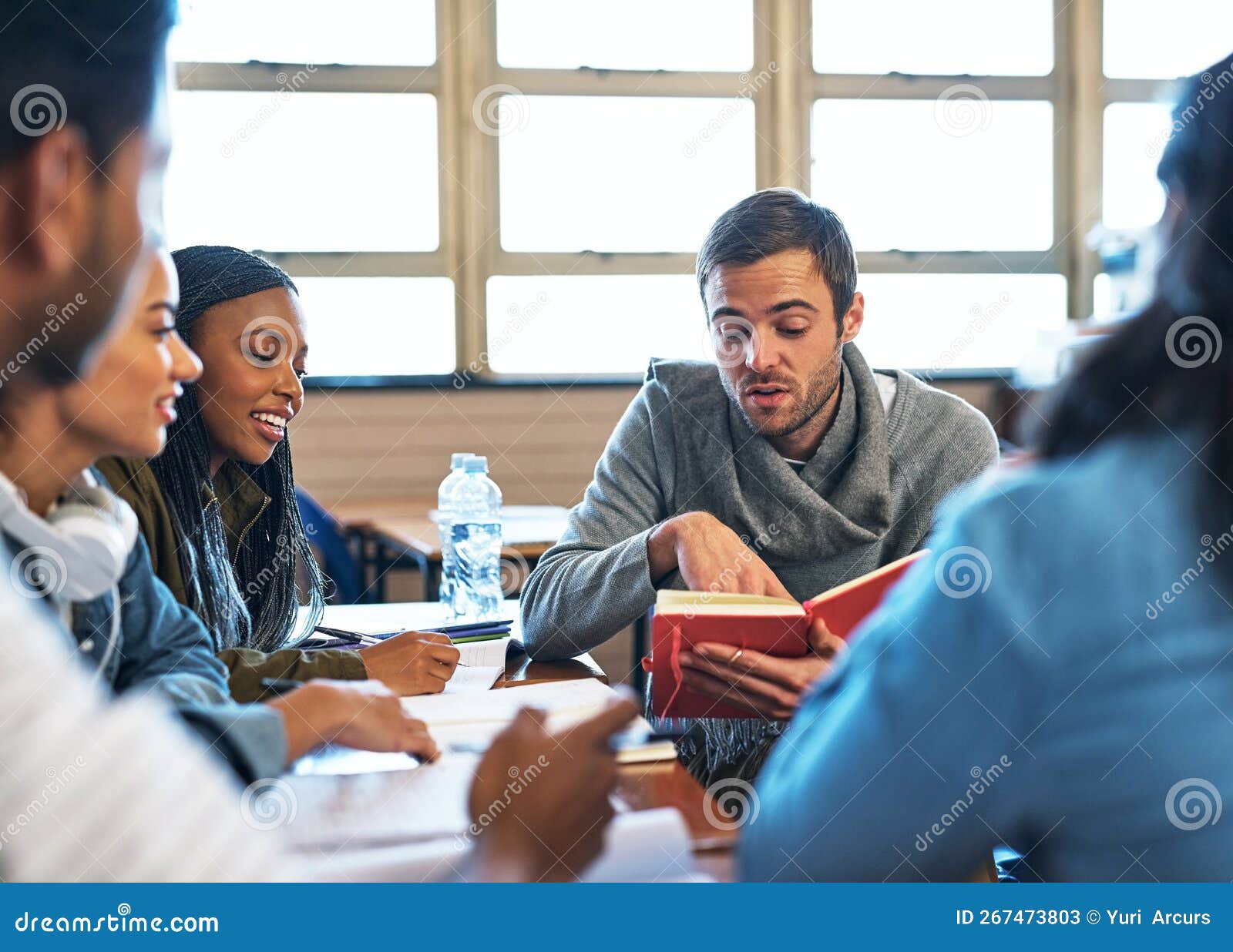 Hes Helping Them Understand. a Group of Young University Students ...