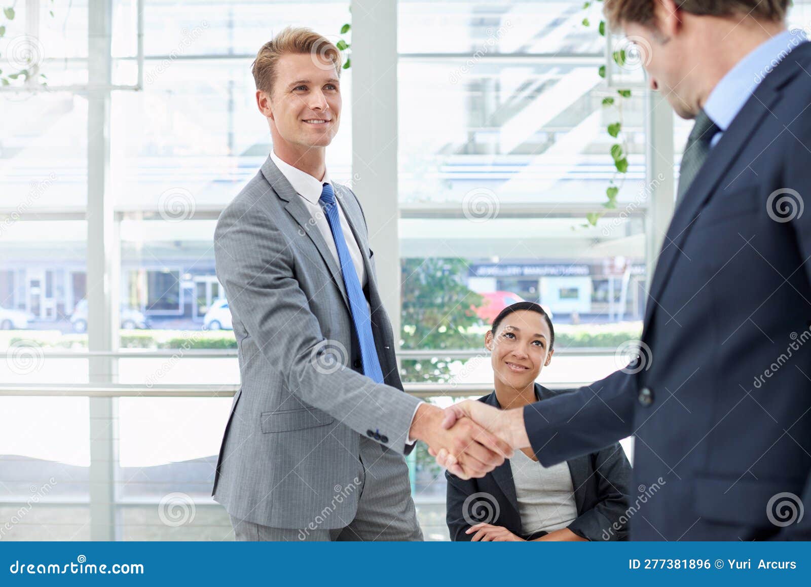 Hes Just Been Promoted. Two Businessmen Shaking Hands in an Office ...