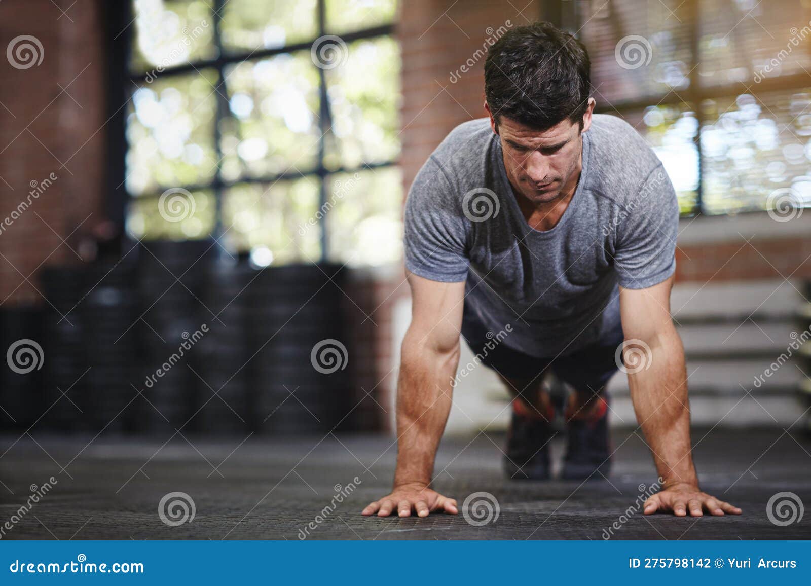 Hes a Lean Mean Machine. a Young Man Doing Pushups in a Gym. Stock ...