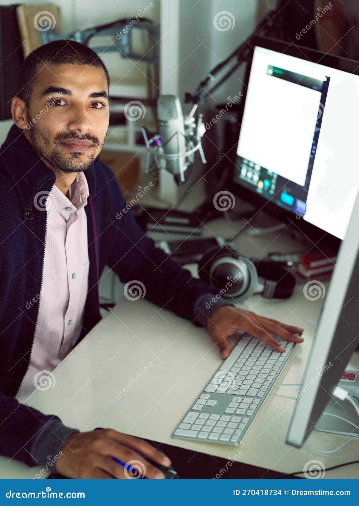 Hes a Multitasking Creative. Portrait of a Focused Young Man Sitting at ...