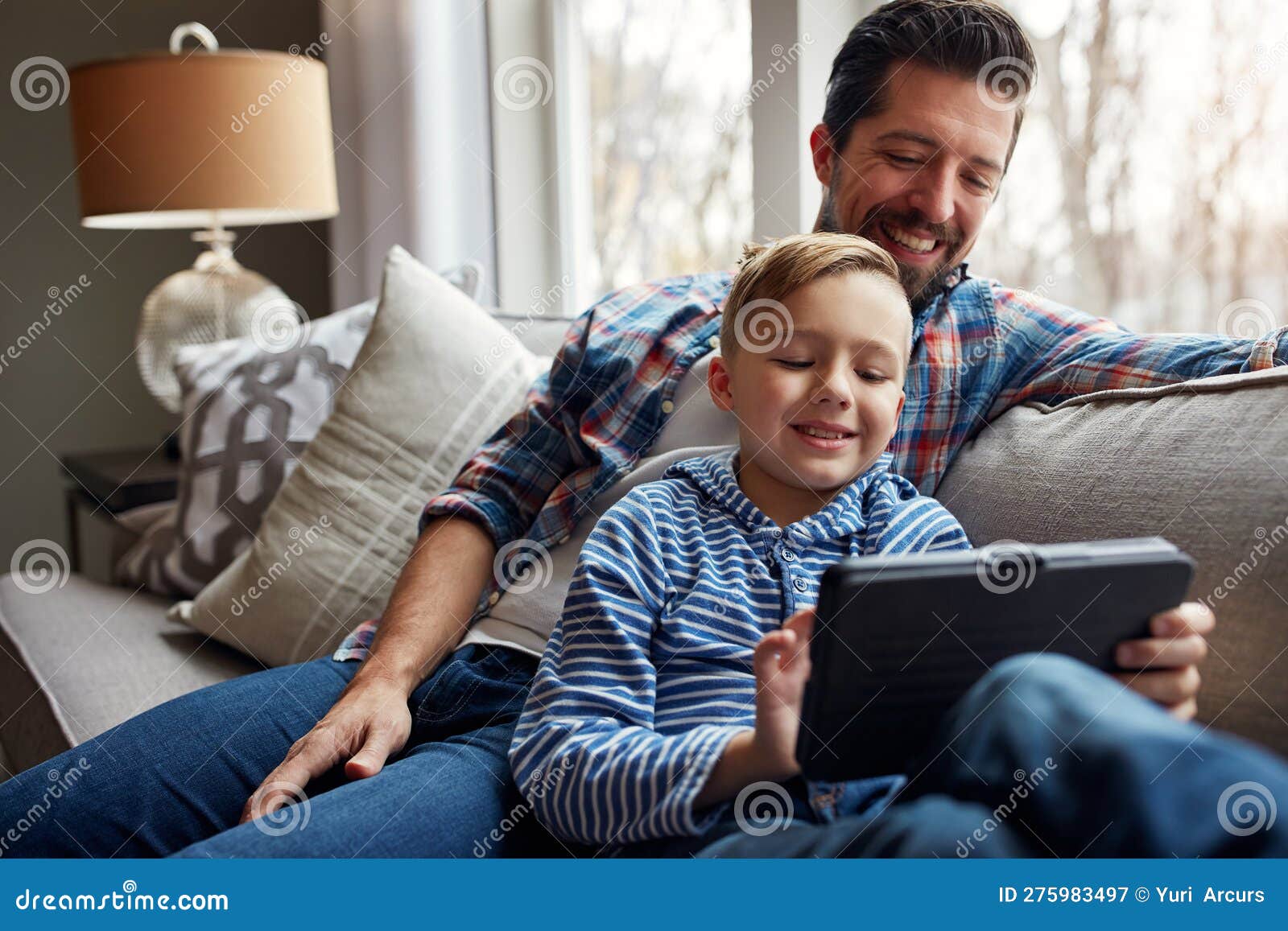 Hes My Tech Savvy Son. a Little Boy Using a Digital Tablet with His ...