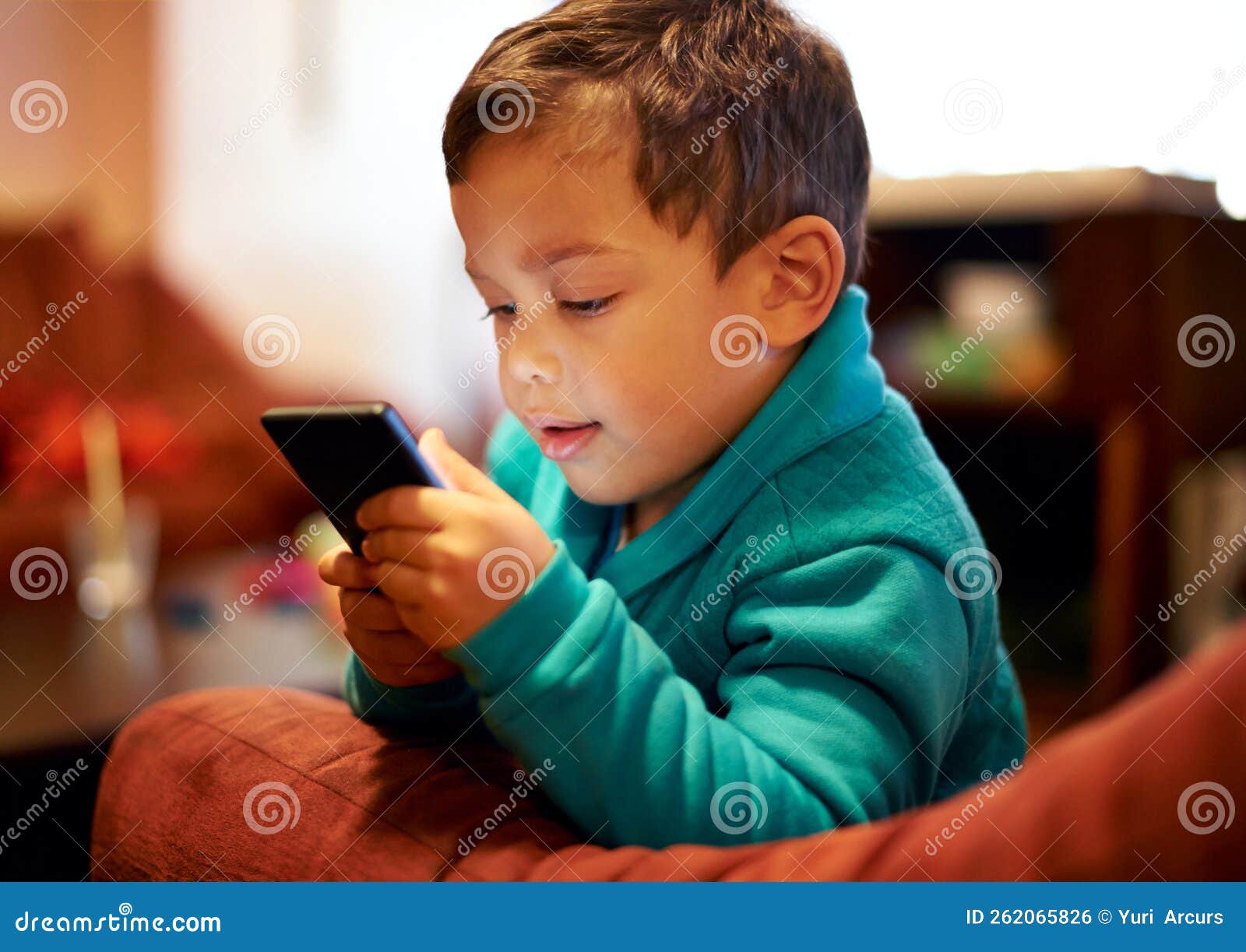 Hes Riveted by that Game. a Little Boy Playing with a Cellphone. Stock ...