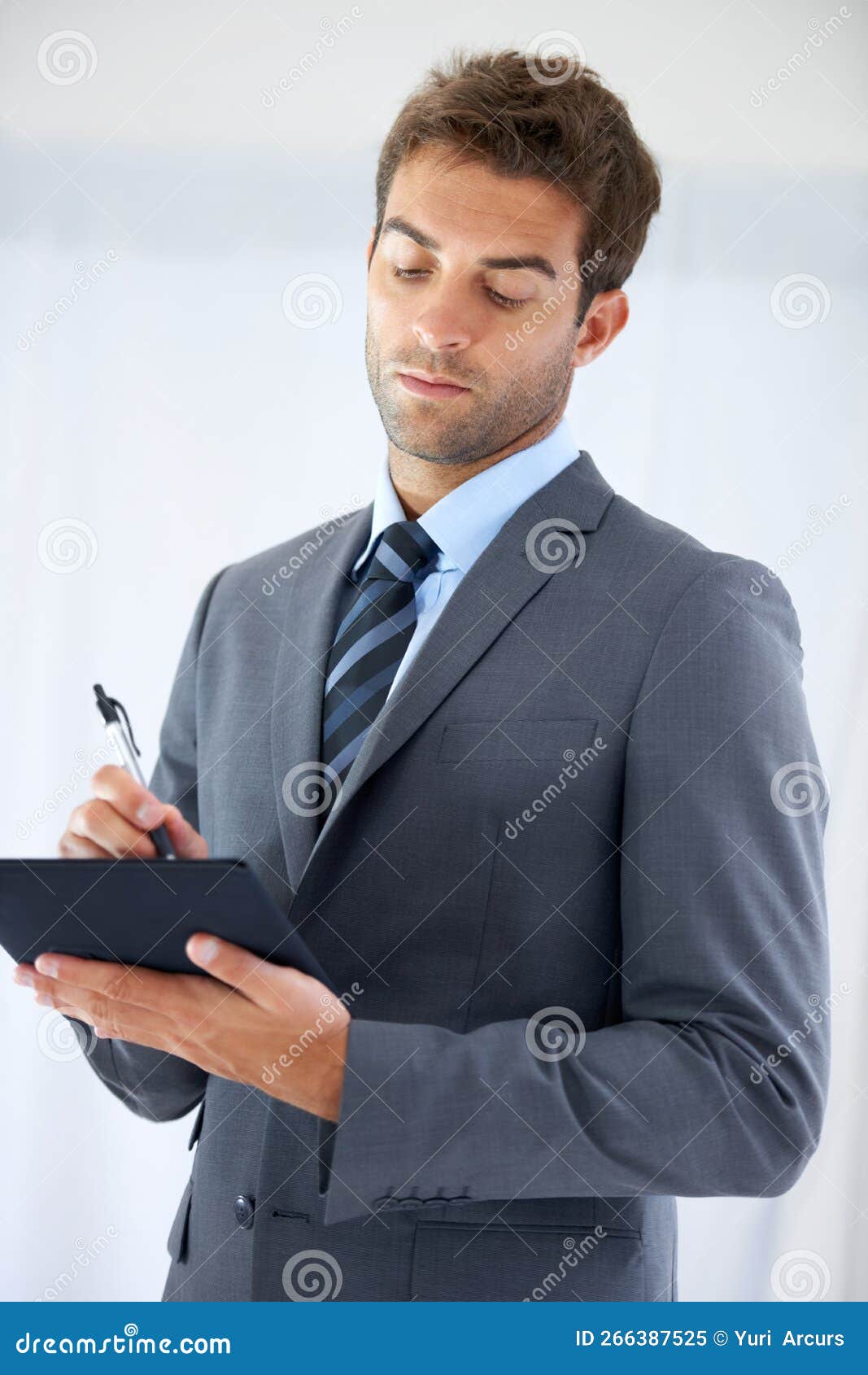 Hes always Taking Note. a Handsome Businessman Standing with a Suit and ...