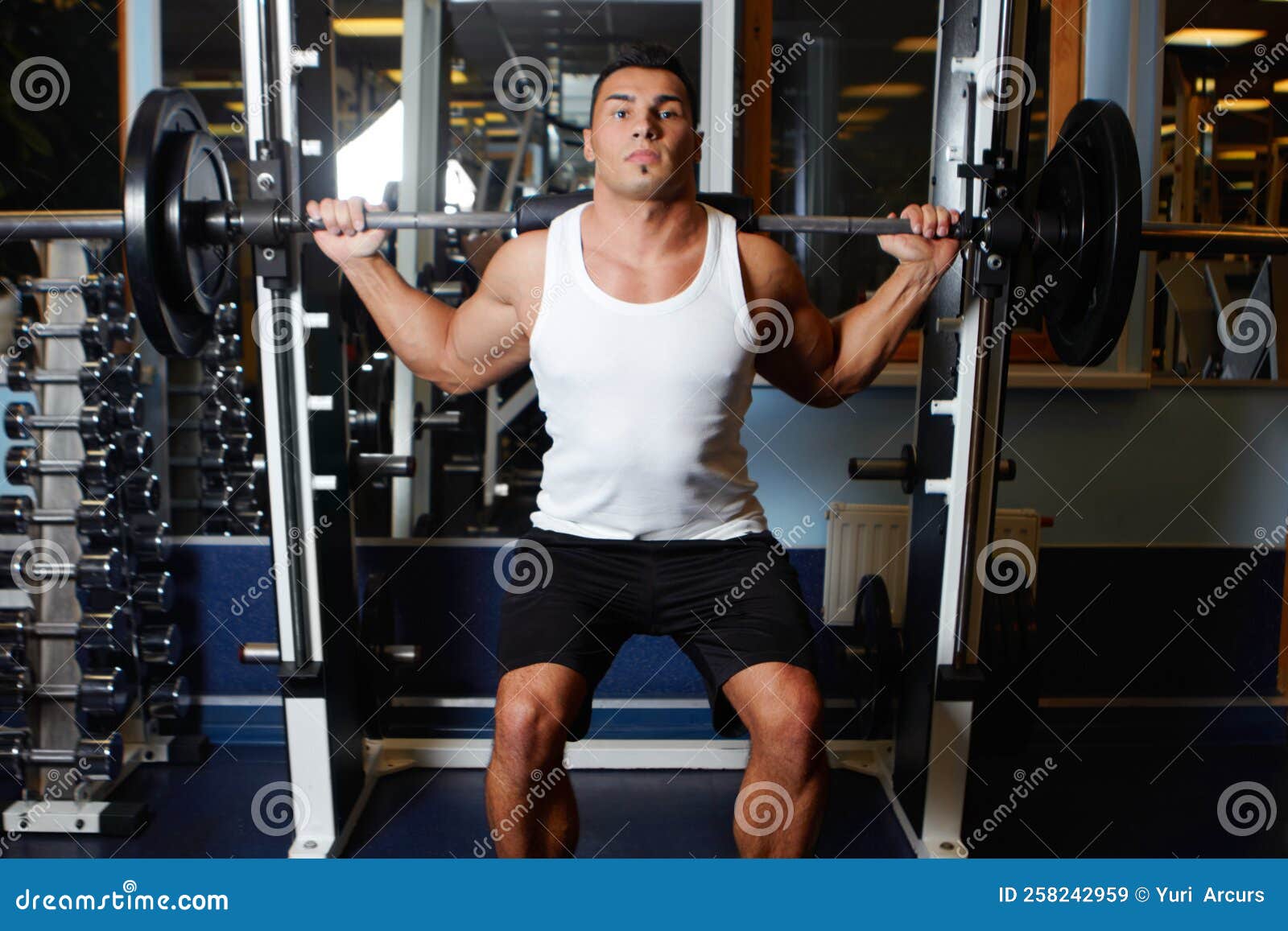 Hes Undefeated at the Gym. a Young Man Lifting a Dumbbell at the Gym ...