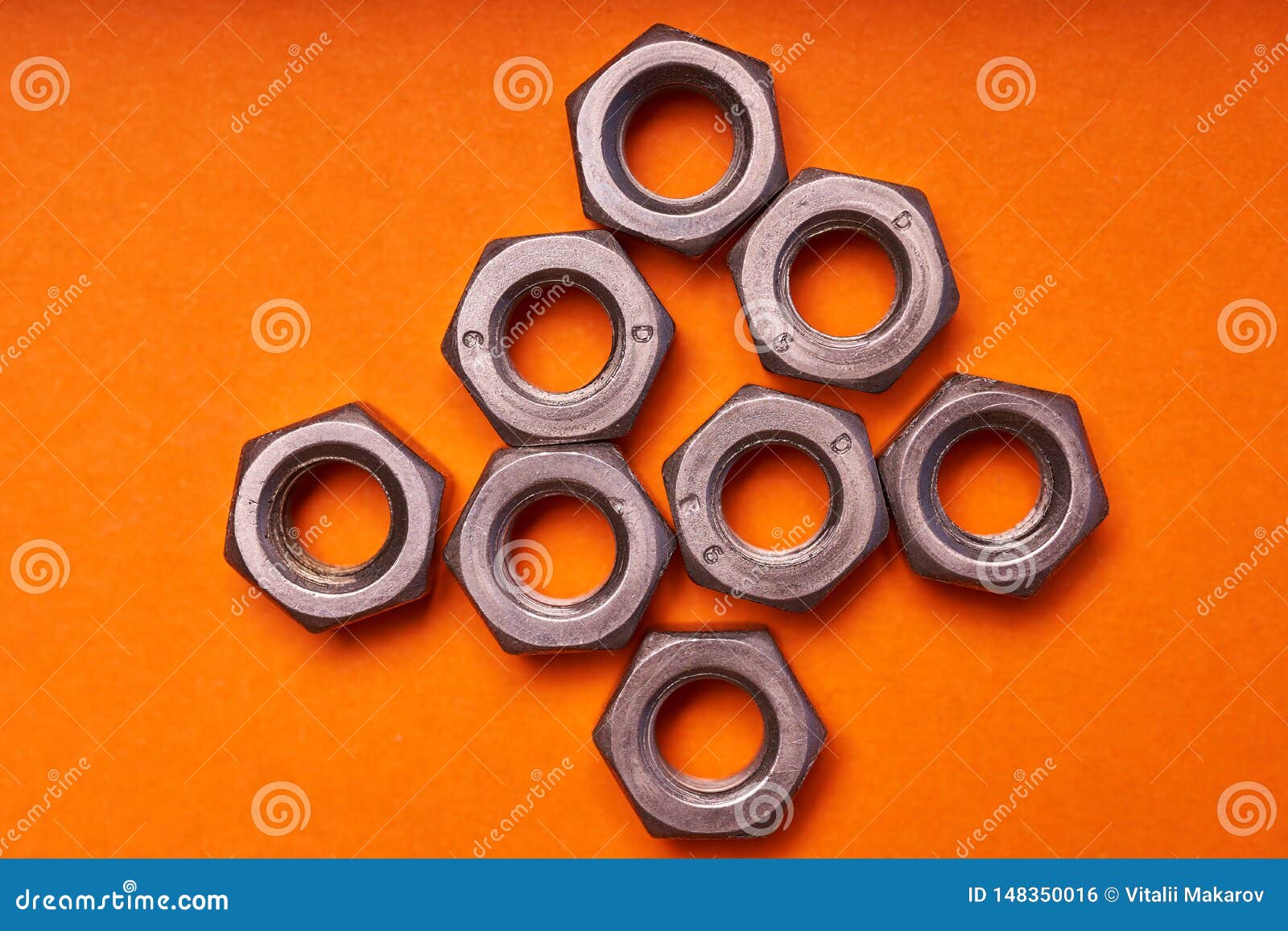 Hex Nuts on Orange Background. Bolted Connection Elements Stock Photo ...