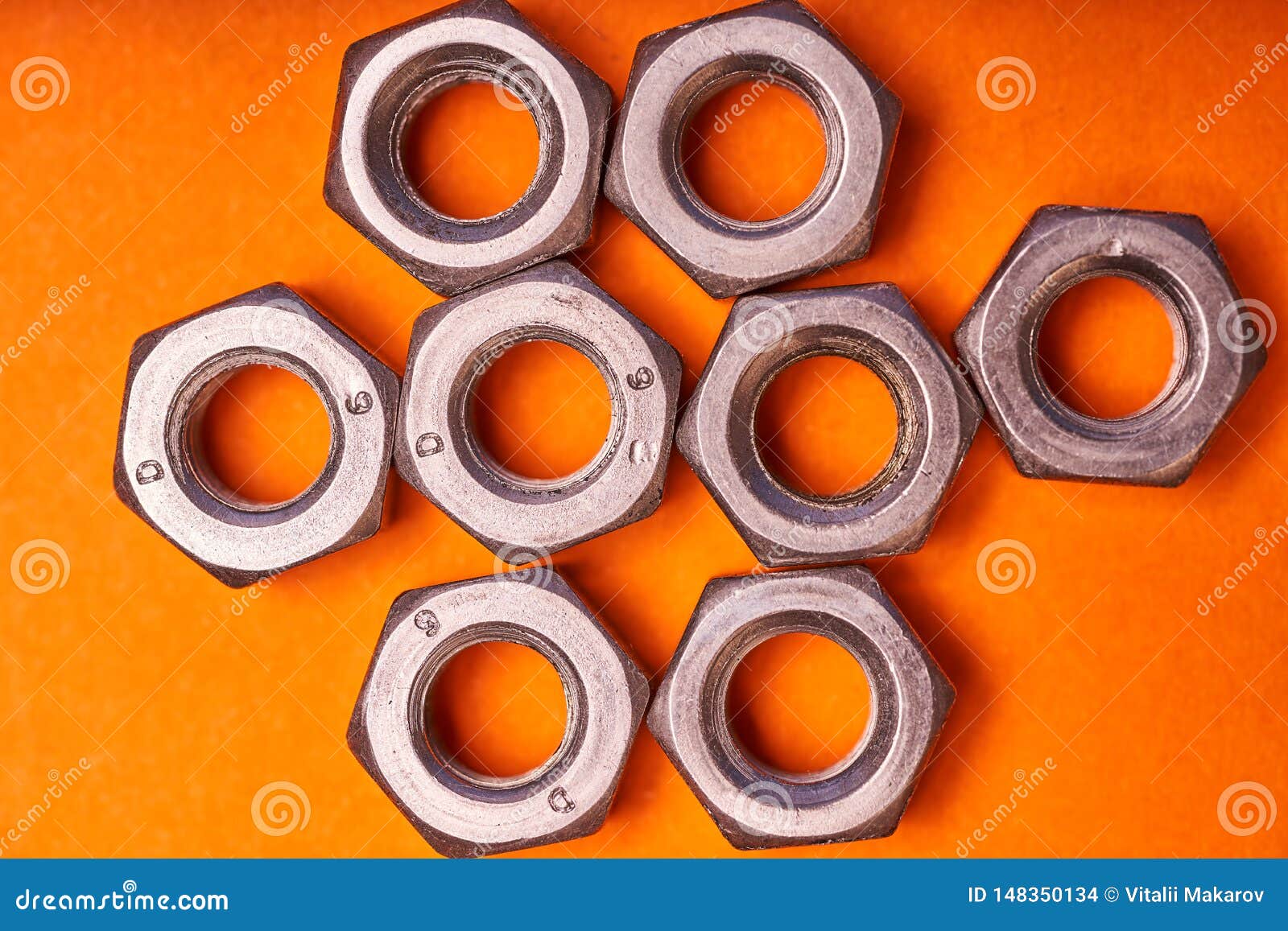 Hex Nuts on Orange Background. Bolted Connection Elements Stock Photo ...