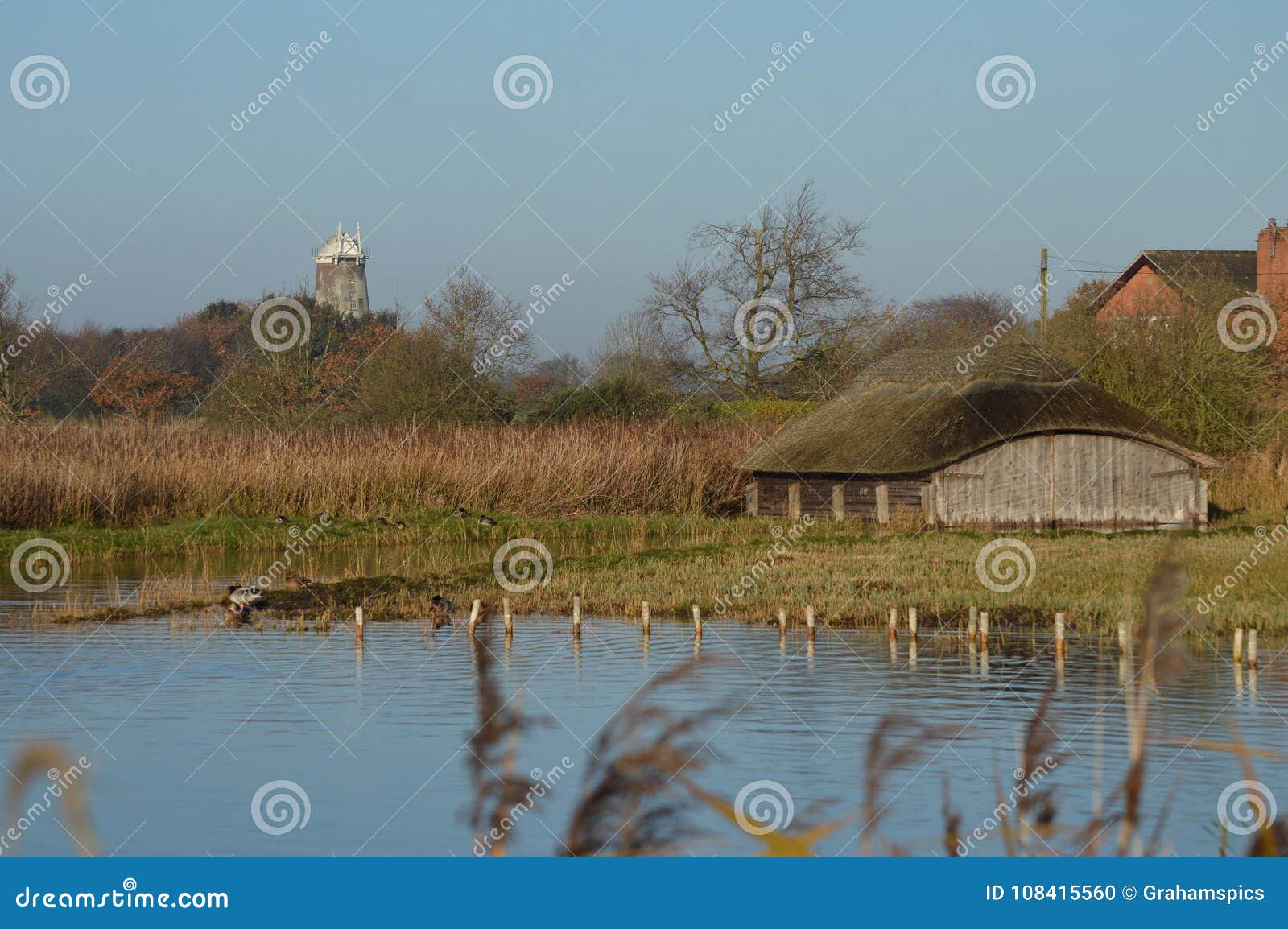 Hickling Broad Norfolk Thatched Boathouses And Windmill Stock Photo ...