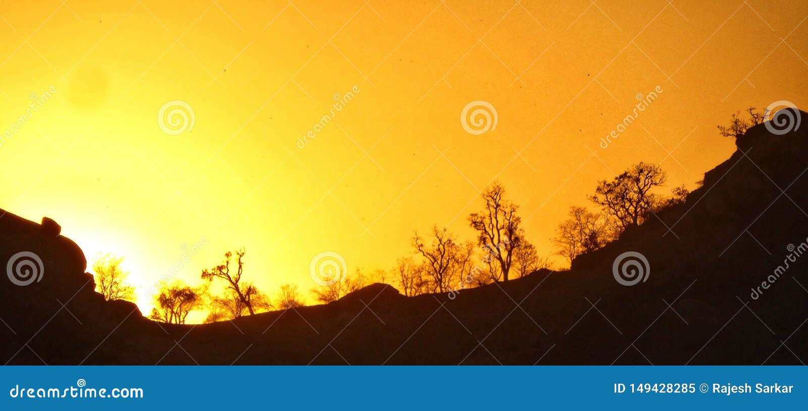 Hiding sun peekaboo stock image. Image of rocks, sunset - 149428285