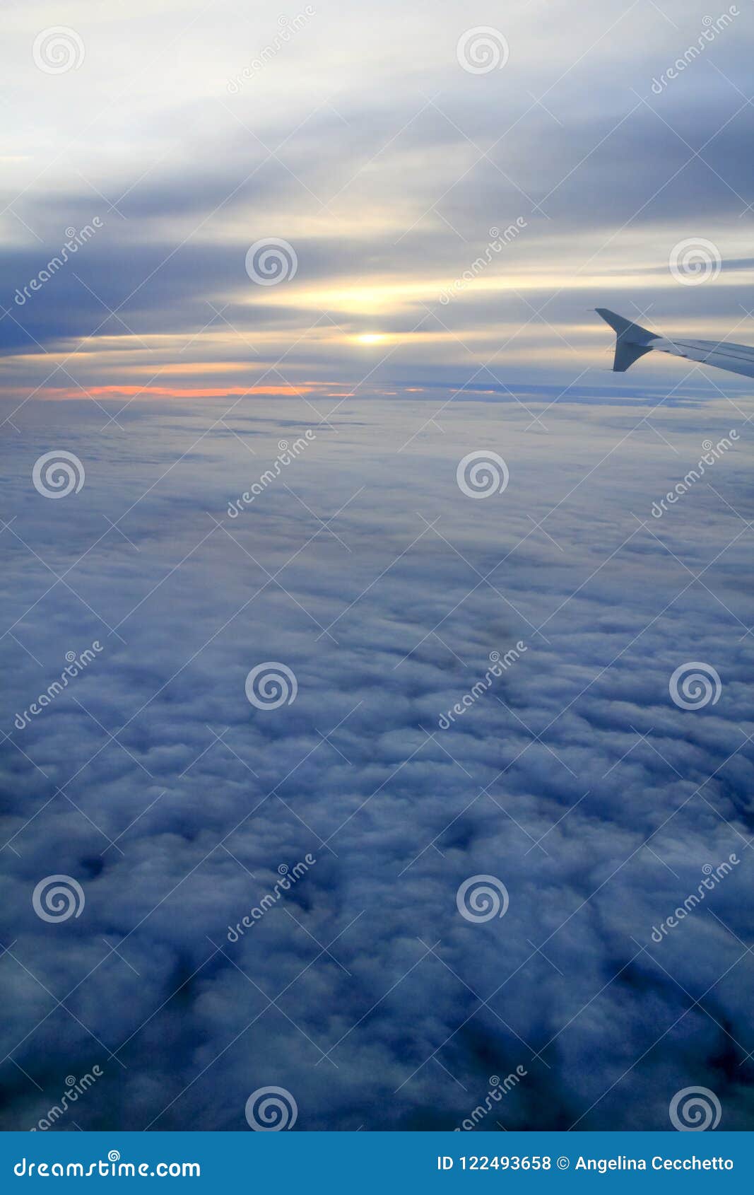 High Altitude Sunset Over the Clouds from a Plane Window Stock Photo ...