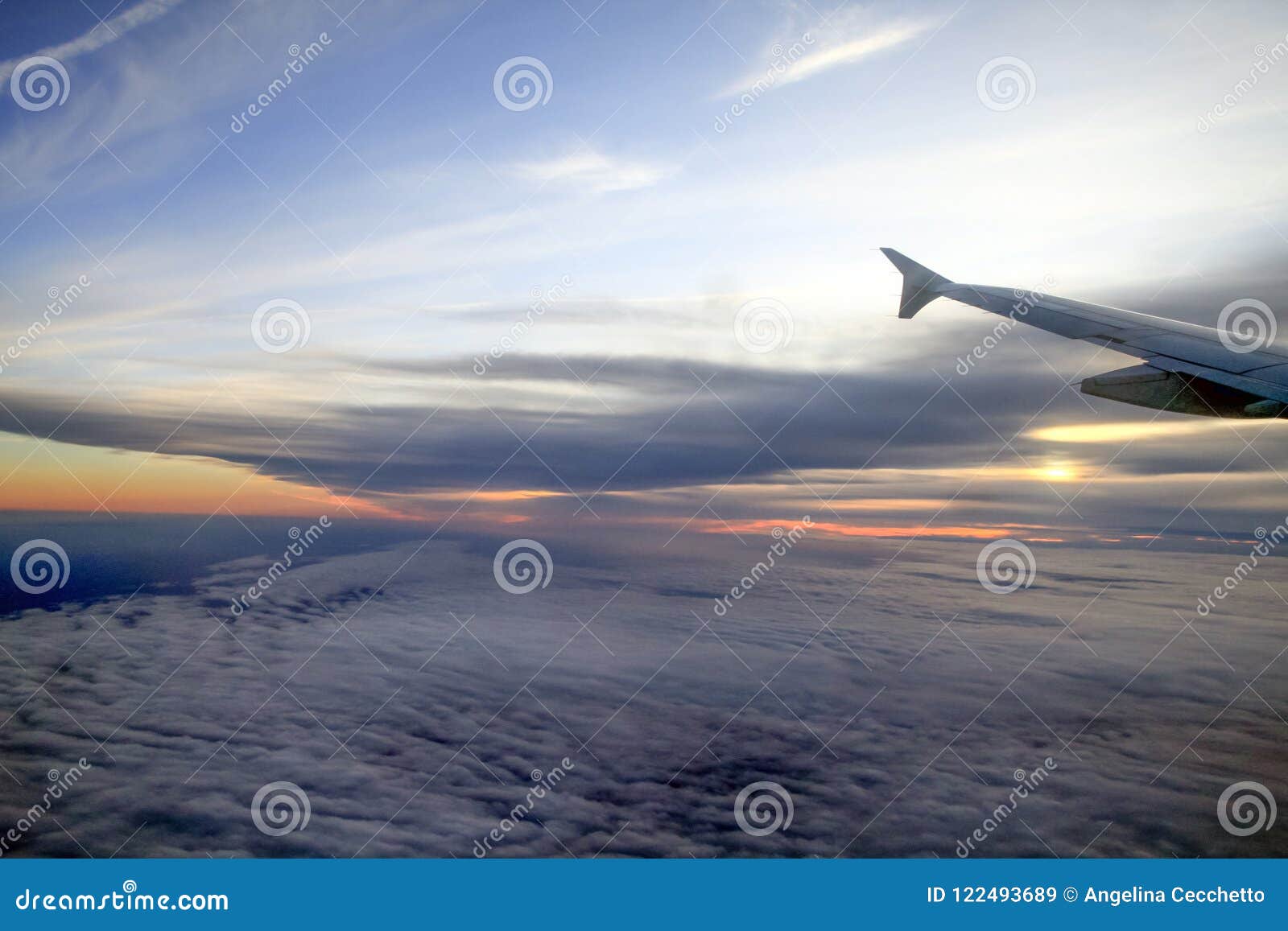 High Altitude Sunset Over the Clouds from a Plane Window Stock Image ...
