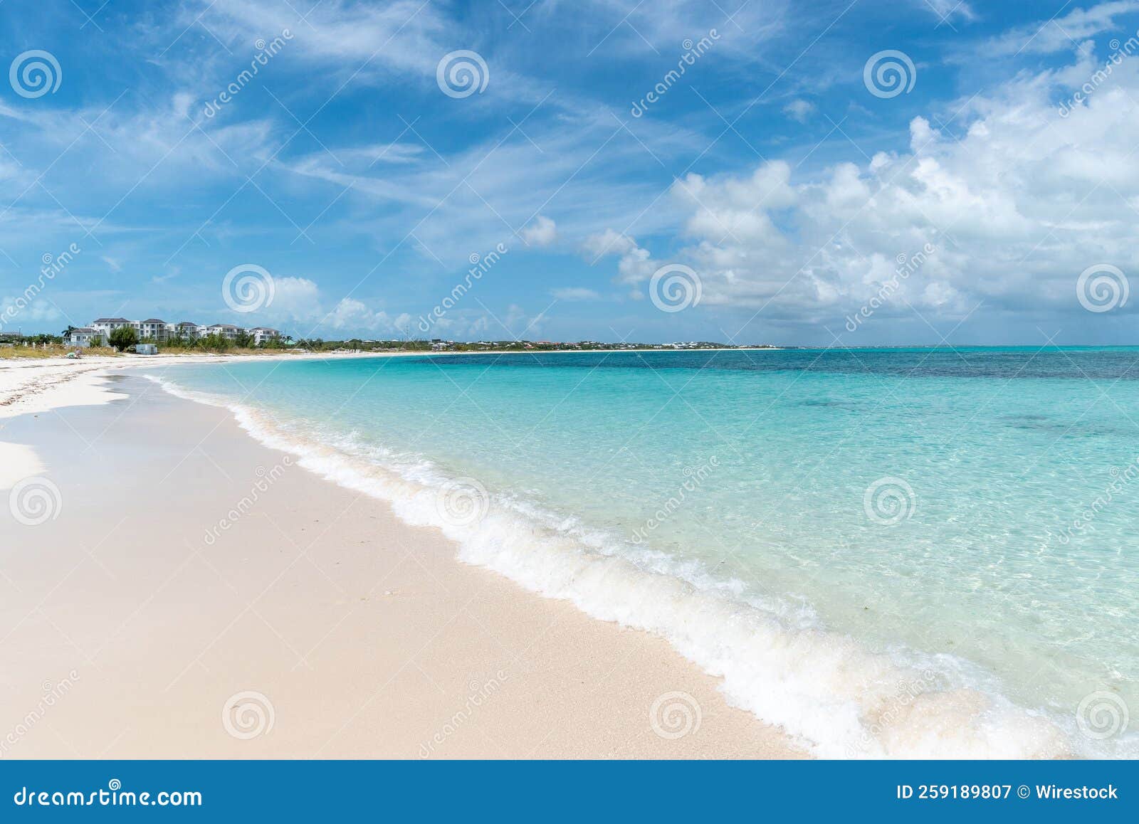 High-angle of a Bight Sandy Beach, Water Waves Making Foam, Cloudy Sky ...