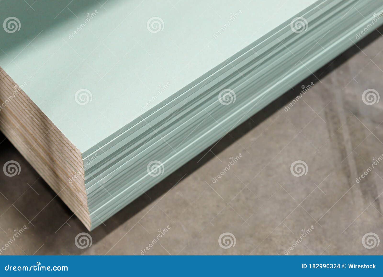 High Angle Closeup of Green Plasterboard on a Grey Surface Stock Photo ...