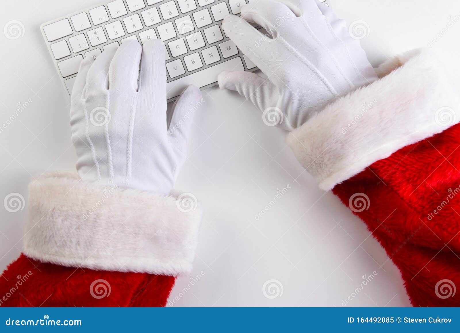 High Angle Closeup of Santa Claus Hands Using His Computer Keyboard ...