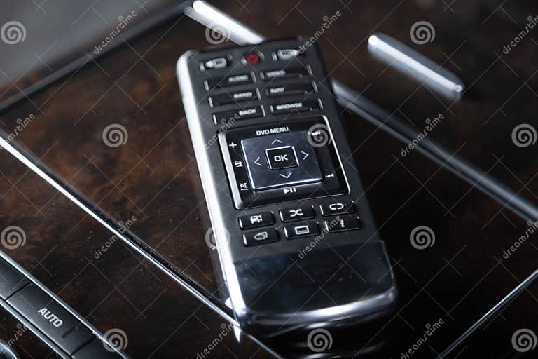 High Angle Closeup Shot of a DVD Remote Control Inside a Modern Car ...