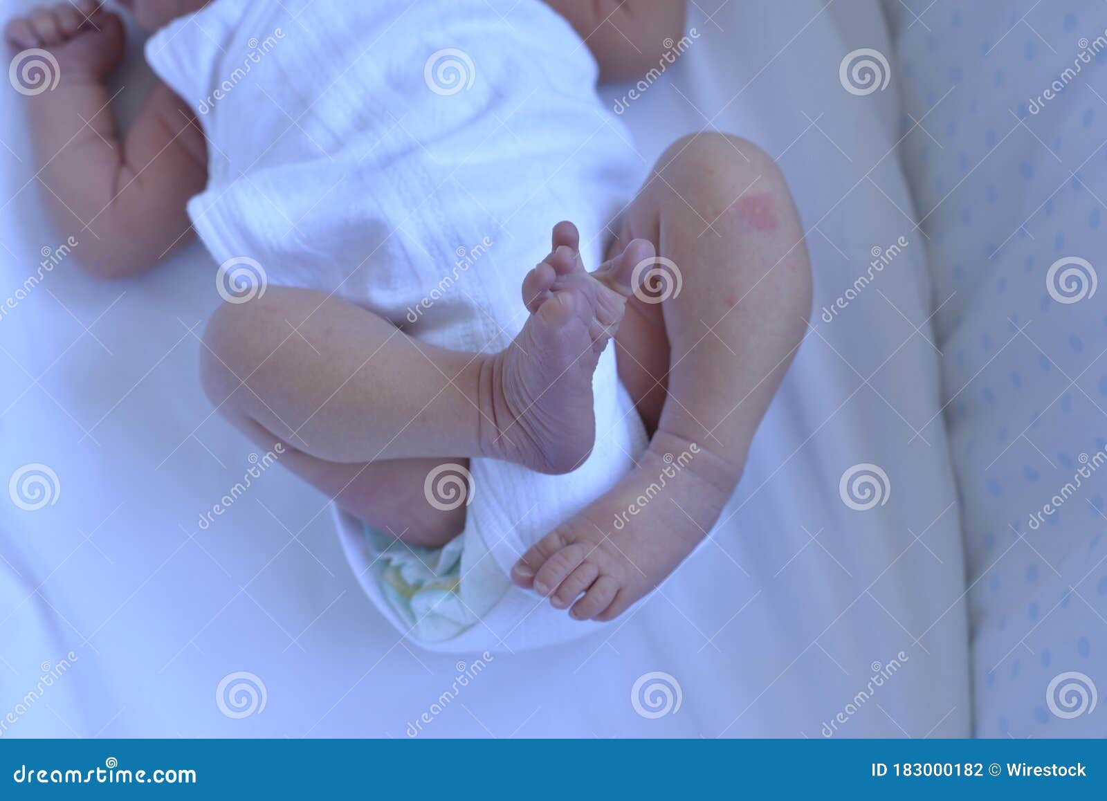 High Angle Shallow Focus Shot of the Legs of a Baby in a Diaper Stock ...