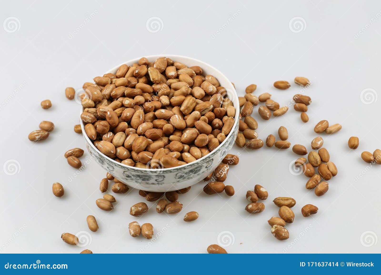 High Angle Shot of a Bowl of Peanuts on a White Surface Stock Photo ...