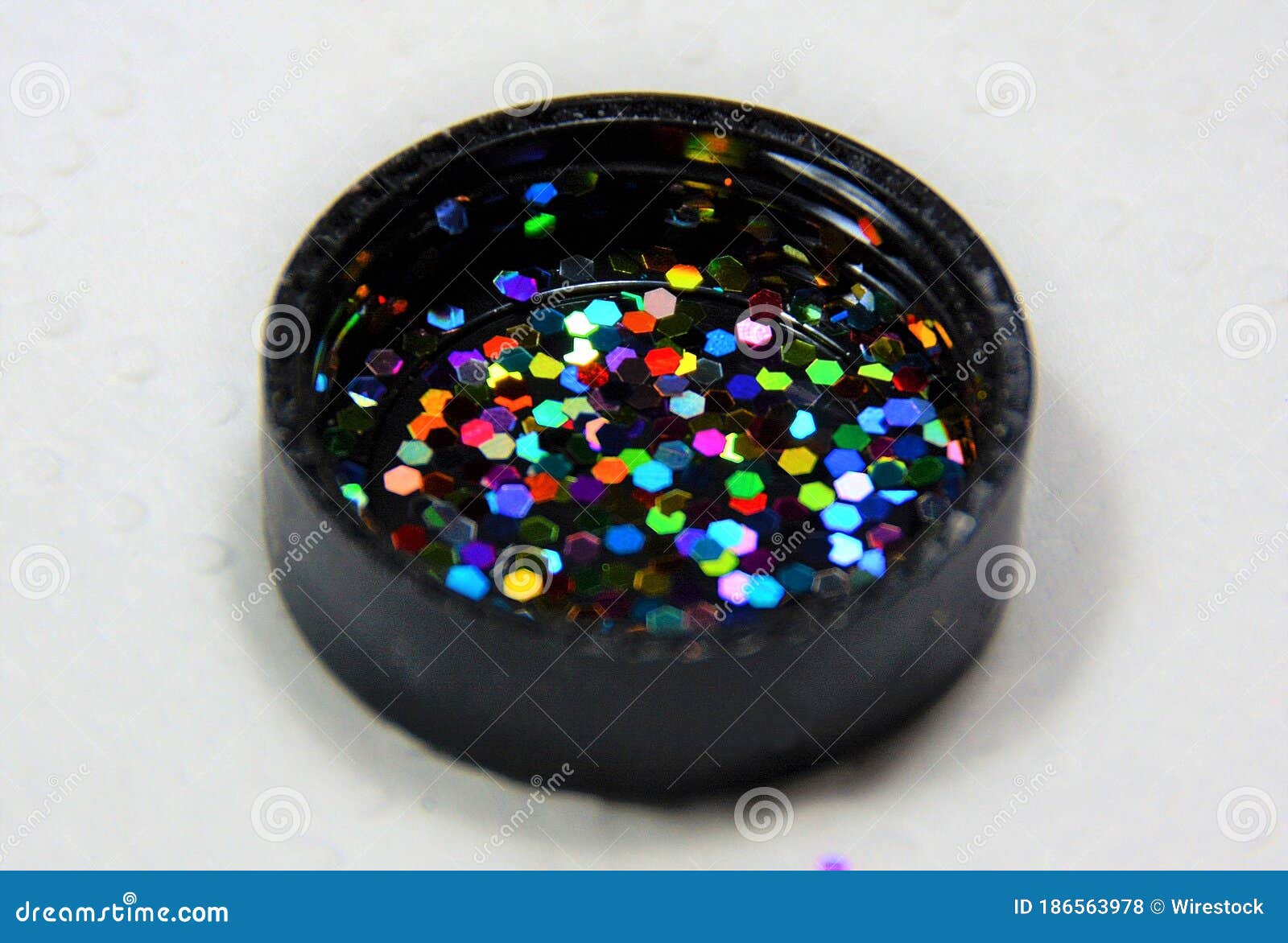 High Angle Shot of Colorful Sparkling Glitter in a Container Against a ...