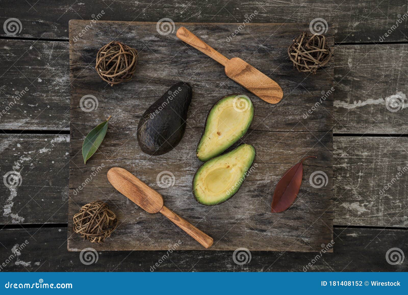 High Angle Shot of Cut Avocados and Wooden Spoons on a Wooden Surface ...