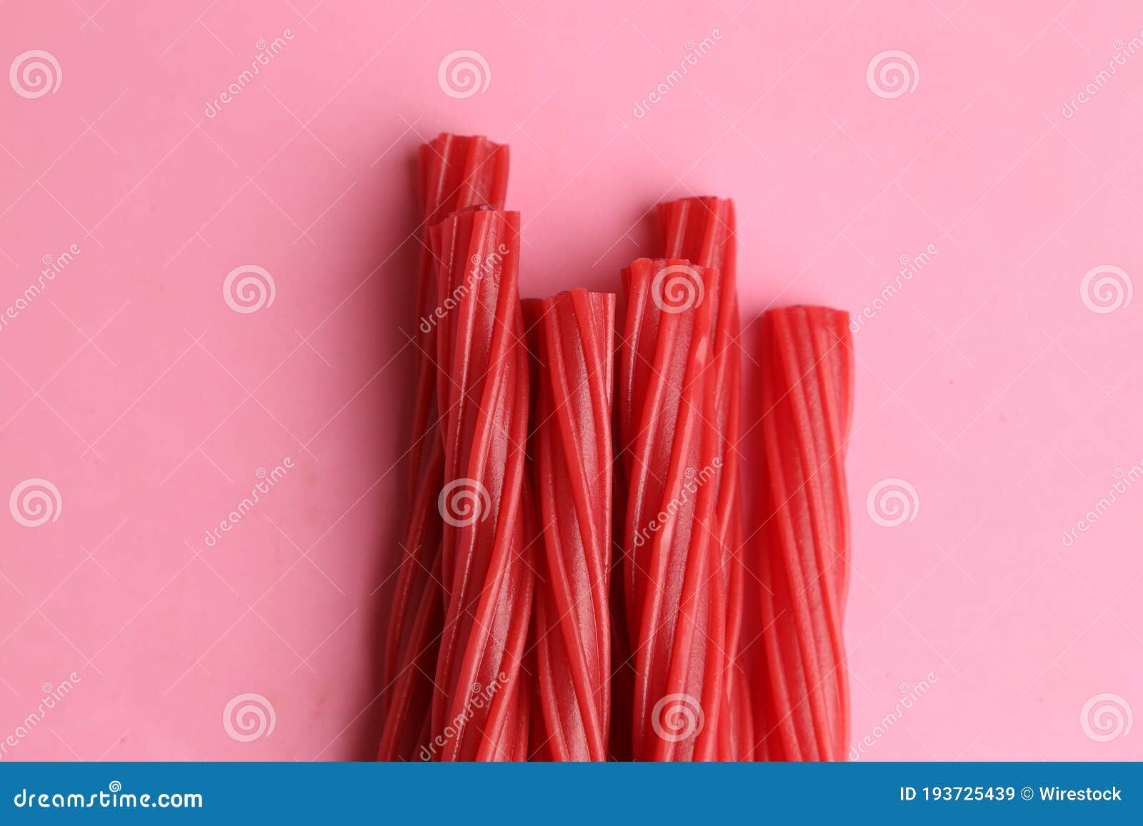 High Angle Shot of Delicious Stick Candies Isolated on a Pink Surface ...