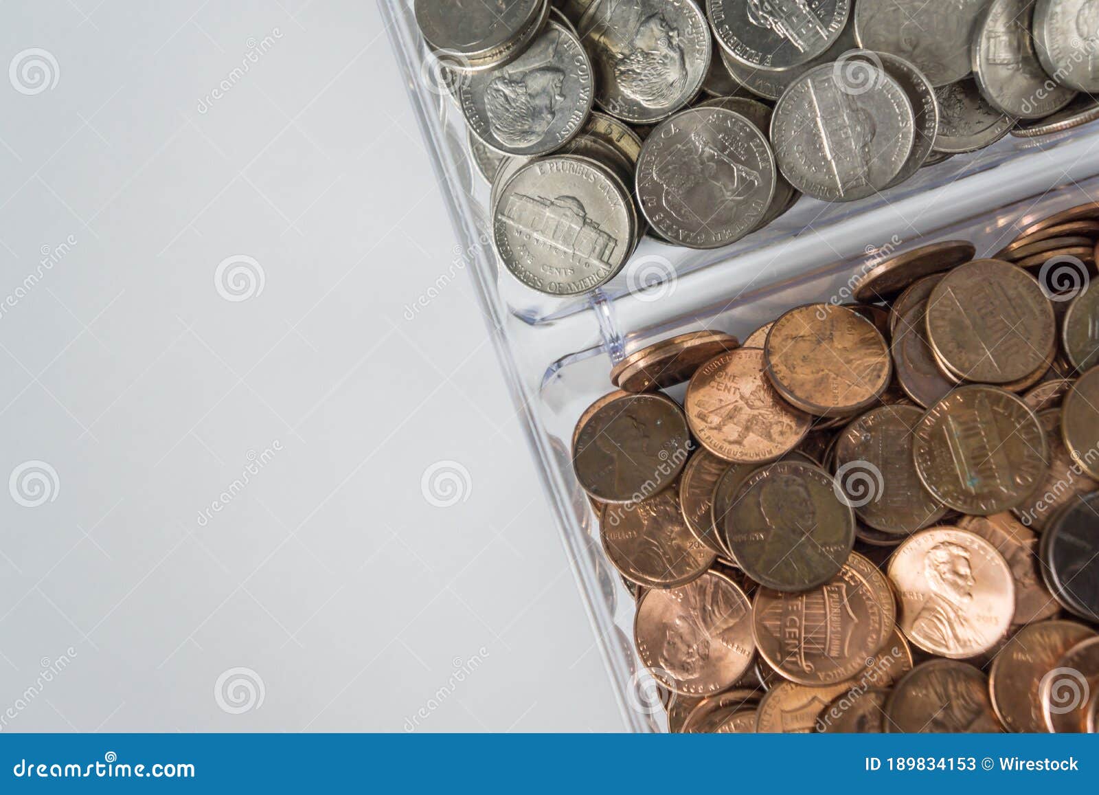 High Angle Shot of Different Coins in Plastic Containers on a White ...
