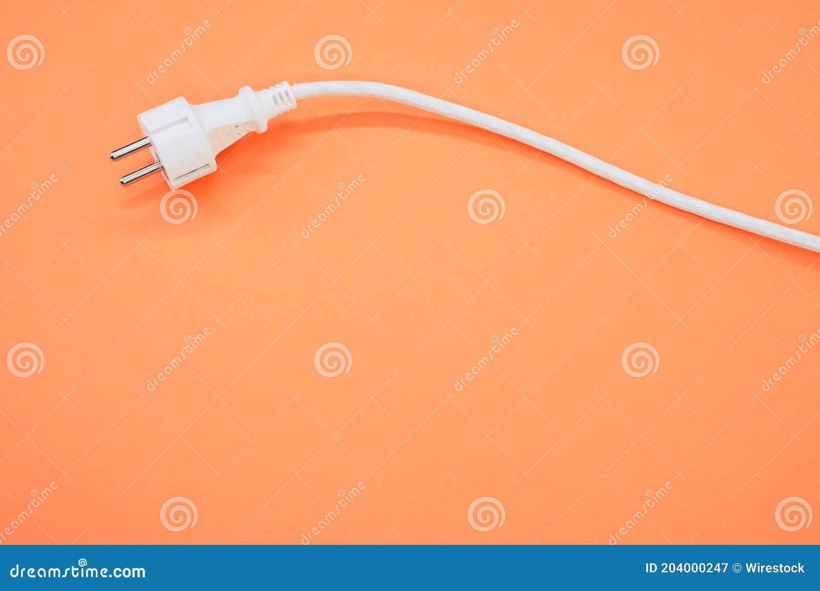 High Angle Shot of an Electrical Wire and Plug on an Orange Surface ...