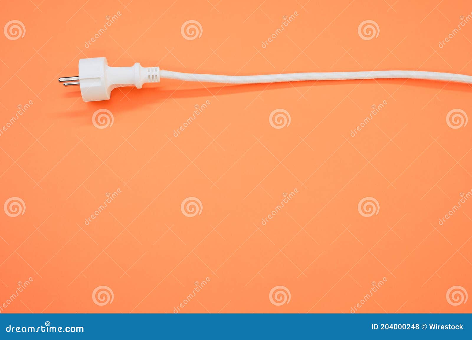 High Angle Shot of an Electrical Wire and Plug on an Orange Surface ...