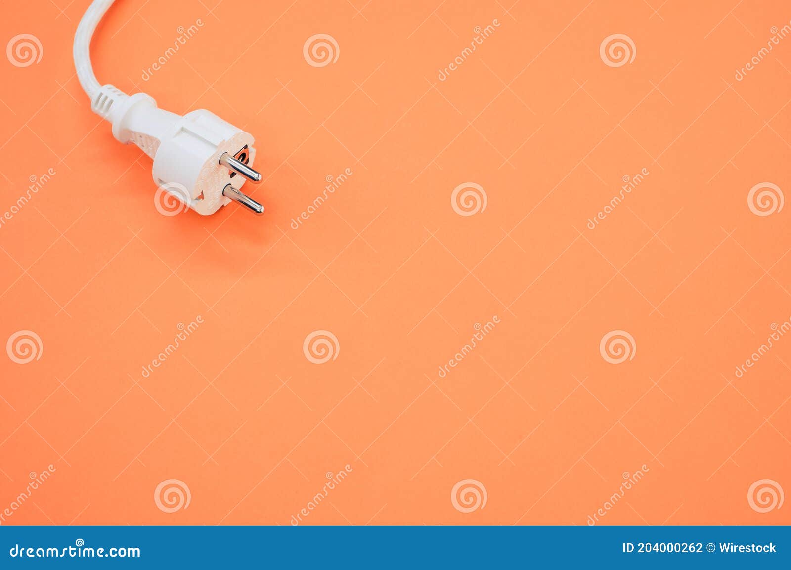 High Angle Shot of an Electrical Wire and Plug on an Orange Surface ...