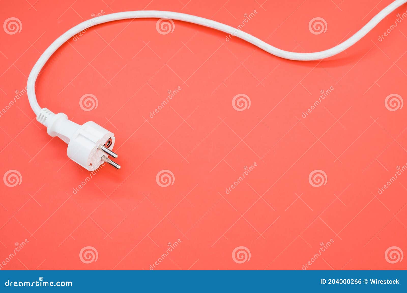High Angle Shot of an Electrical Wire and Plug on a Pink Surface Stock ...