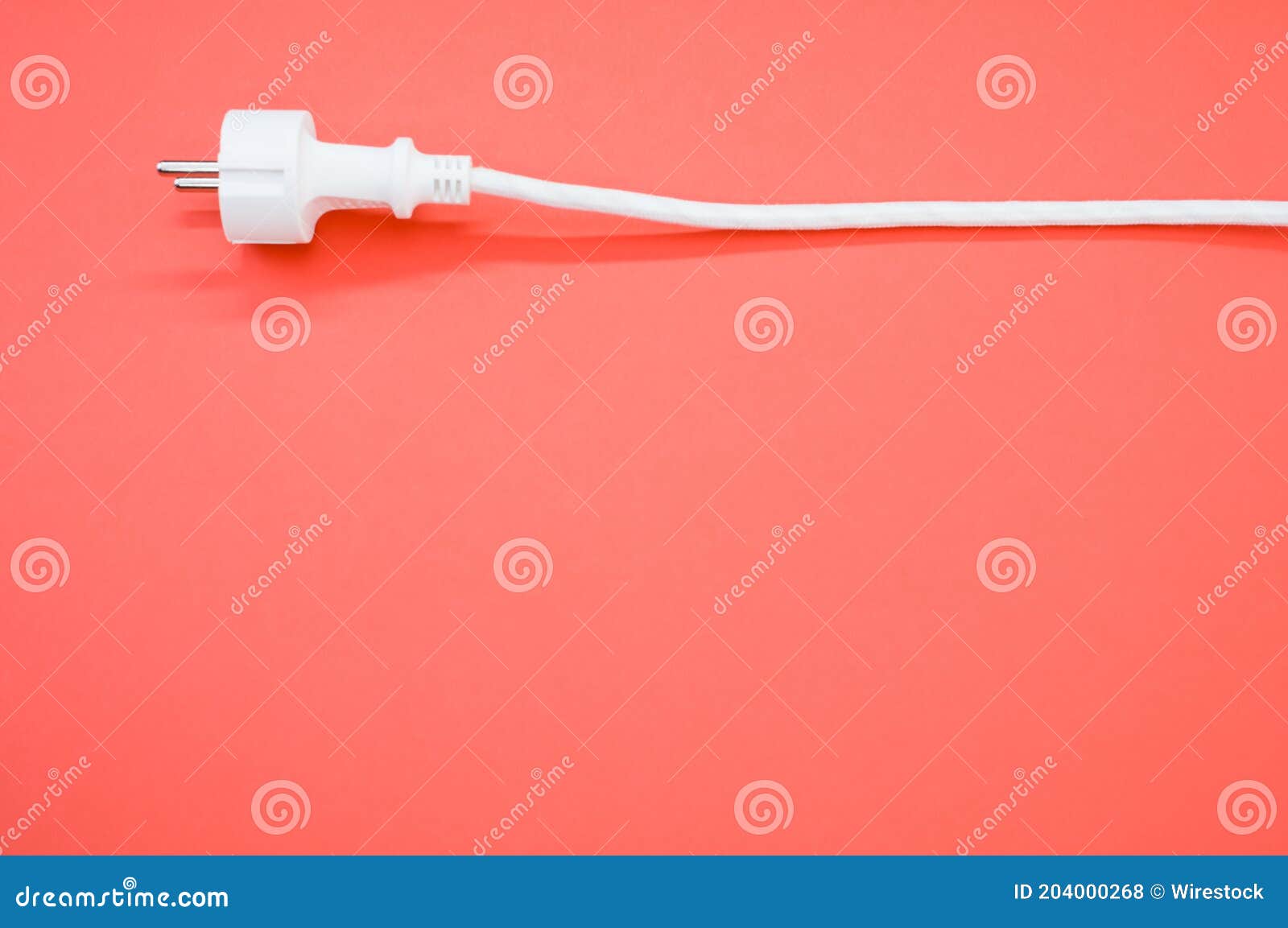 High Angle Shot of an Electrical Wire and Plug on a Pink Surface Stock ...
