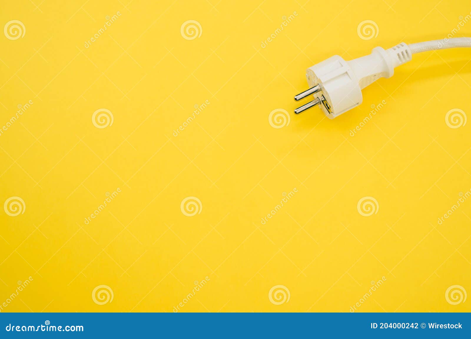 High Angle Shot of an Electrical Wire and Plug on a Yellow Surface ...