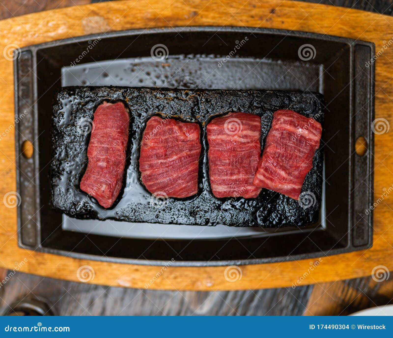 High Angle Shot of Fresh Beef Meat Cooked on a Hot Stone Stock Photo ...