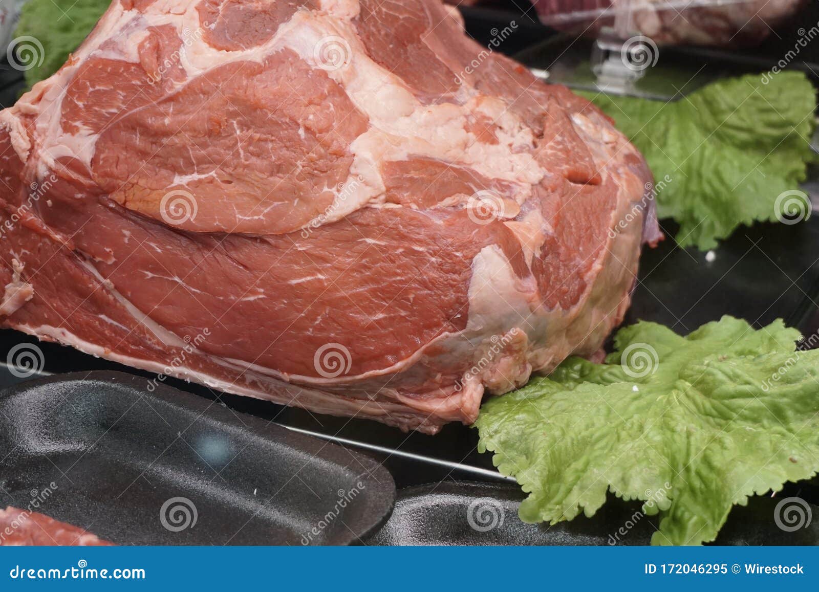 High Angle Shot of Fresh Meat with Green Lettuce with a Blurred ...