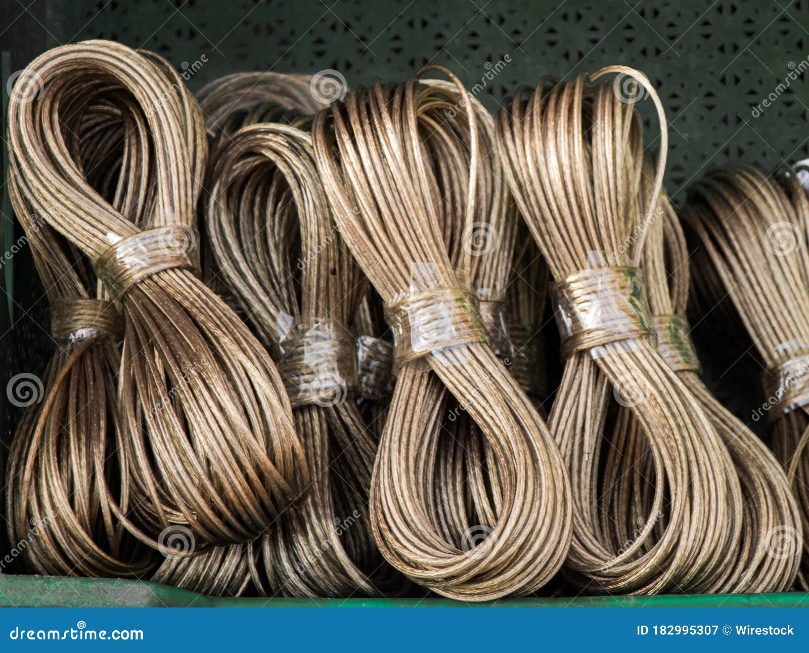 High Angle Shot of Golden Packs of Wires Placed on Each Other on a Grey ...