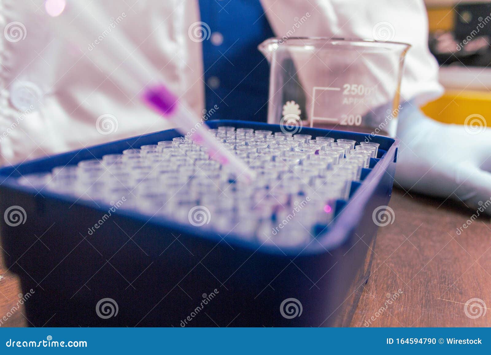 High Angle Shot of a Laboratory Assistant Adding Purple Liquid in Test ...
