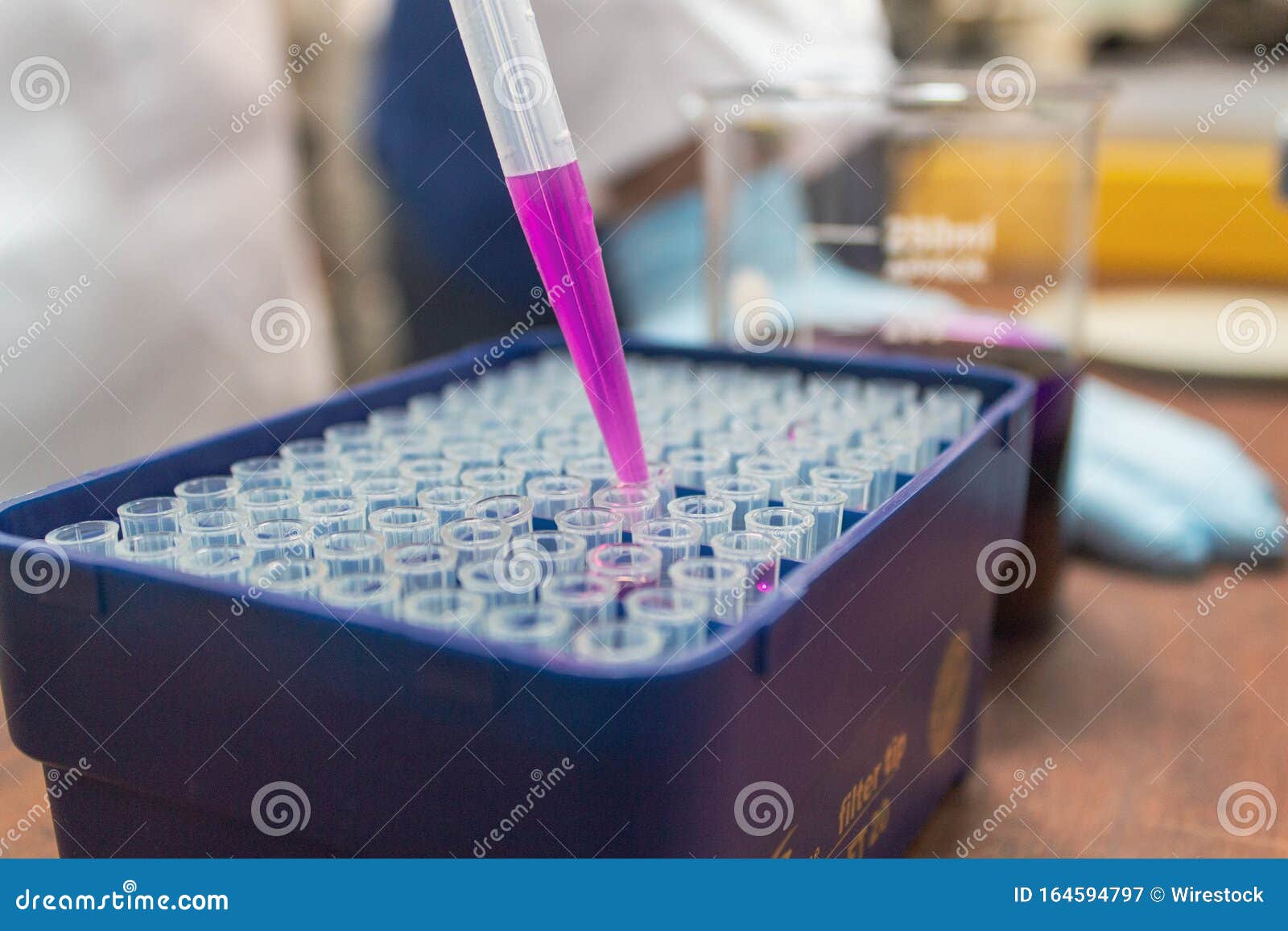 High Angle Shot of a Laboratory Assistant Adding Purple Liquid in Test ...