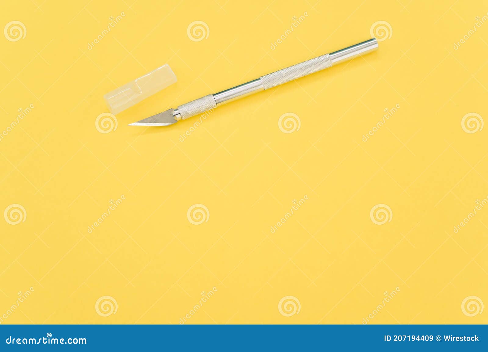 High Angle Shot of Metallic Scalpel with Cap Isolated on Yellow ...
