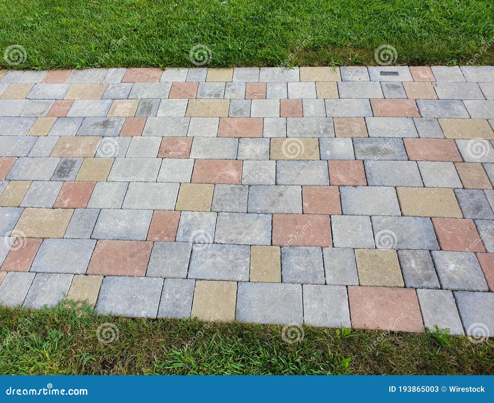 High Angle Shot of a Paver Walkway Surrounded by Green Grass Stock ...