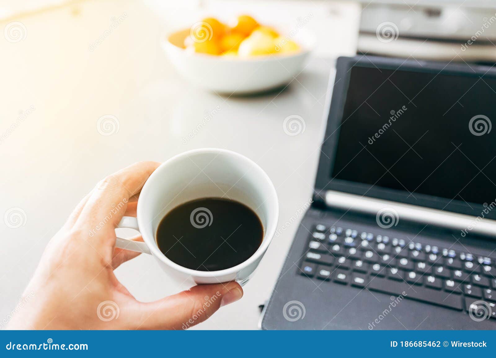 High Angle Shot of a Person Drinking Coffee while Working on the ...