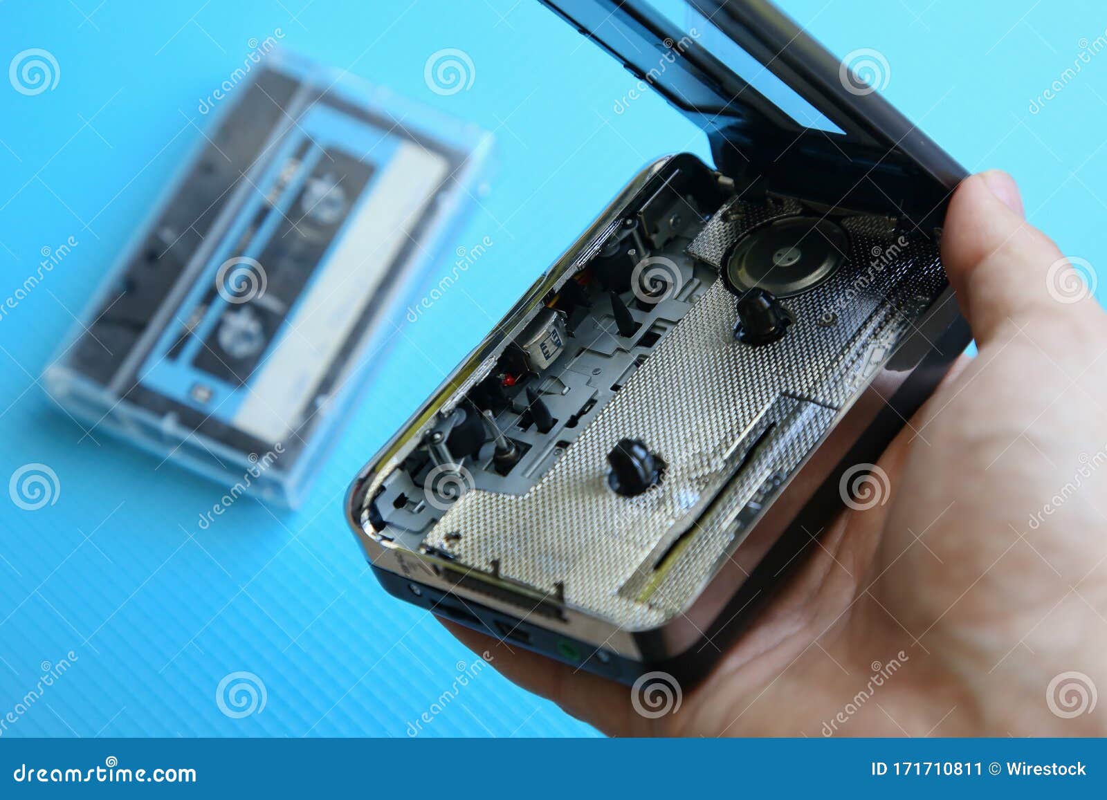 High Angle Shot of a Person Holding a Cassette Player with a Cassette ...